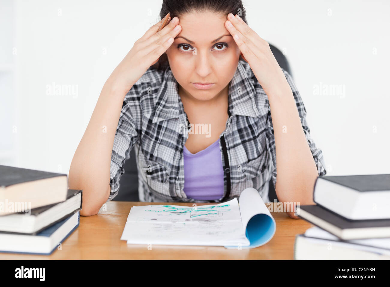 Stressed student with homework looking to camera Stock Photo - Alamy