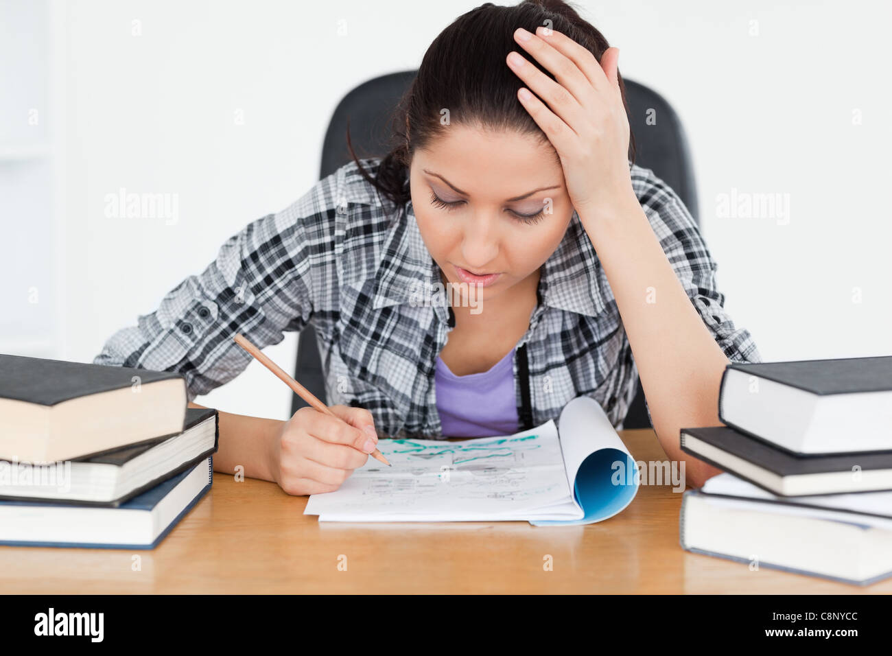 Tired young student learning Stock Photo - Alamy