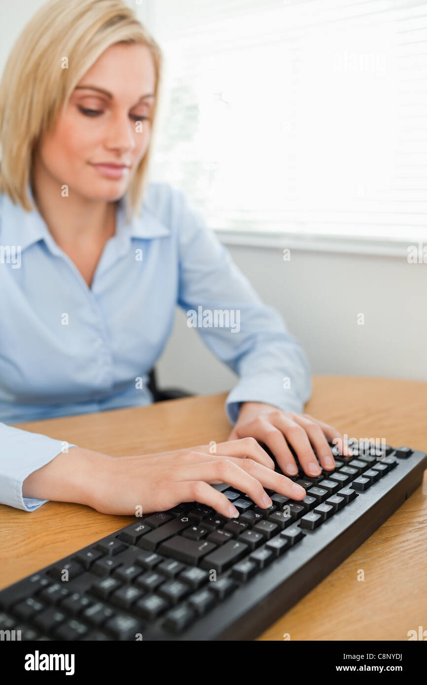Typing woman looking at keyboard Stock Photo - Alamy