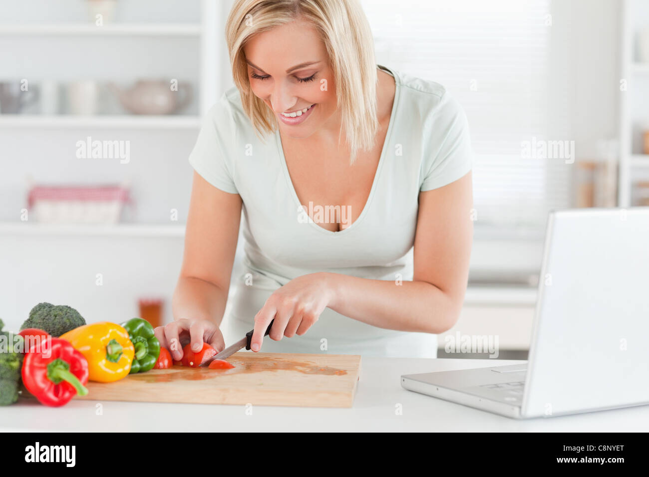 Woman enjoying to cook Stock Photo - Alamy
