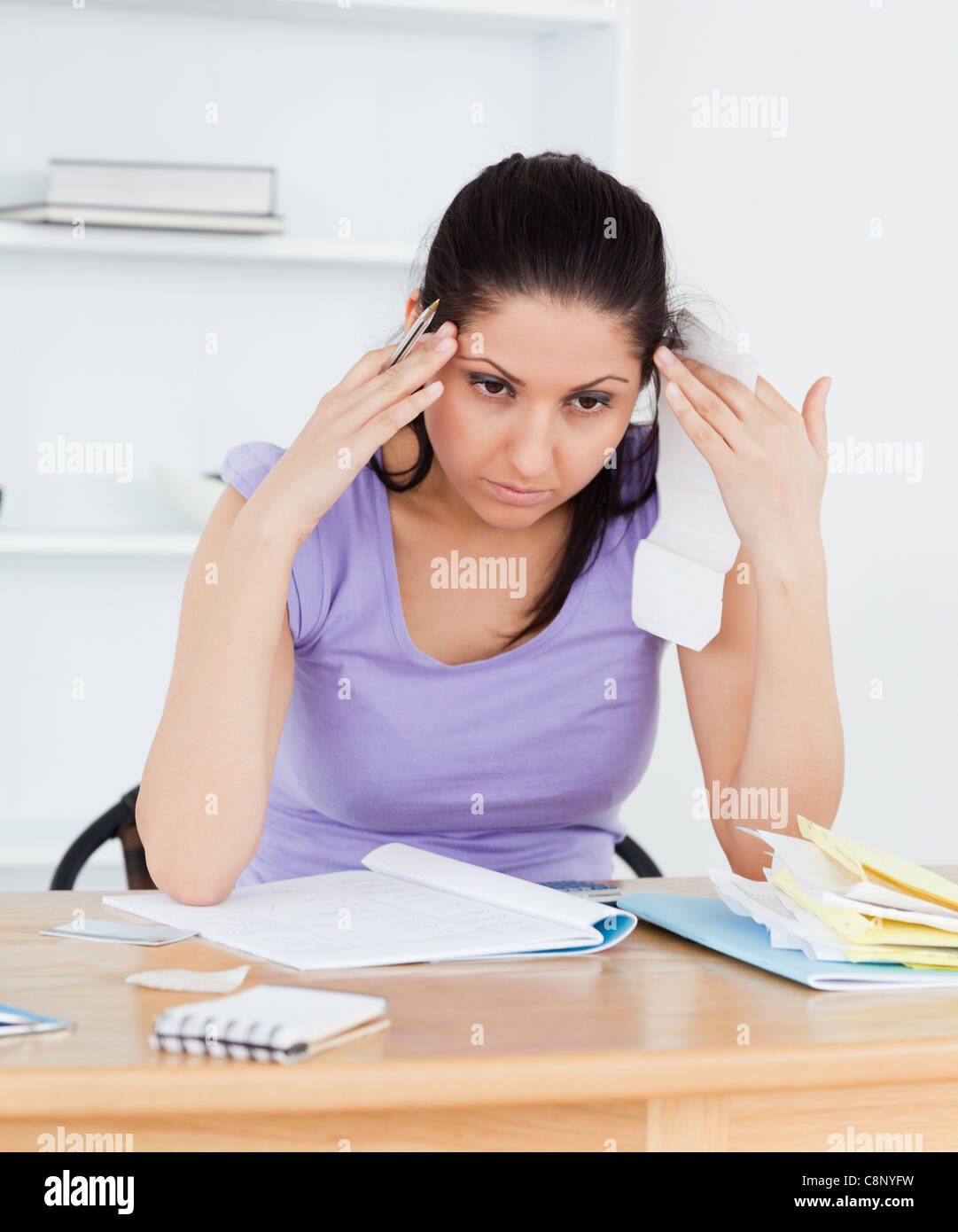 Young accounting woman having a headache Stock Photo - Alamy