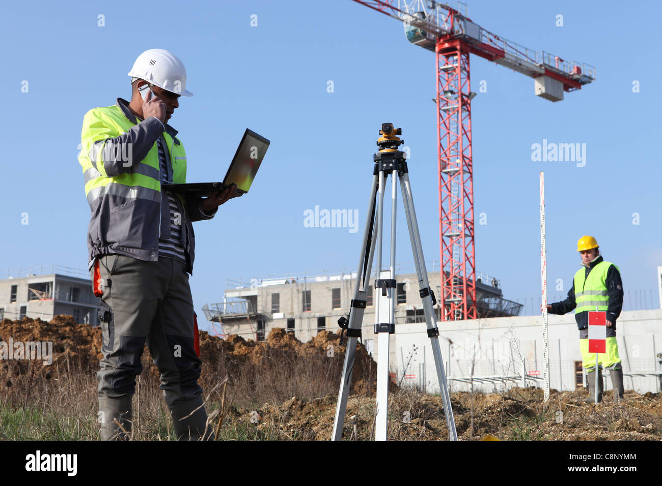 Two surveyors working on site Stock Photo - Alamy