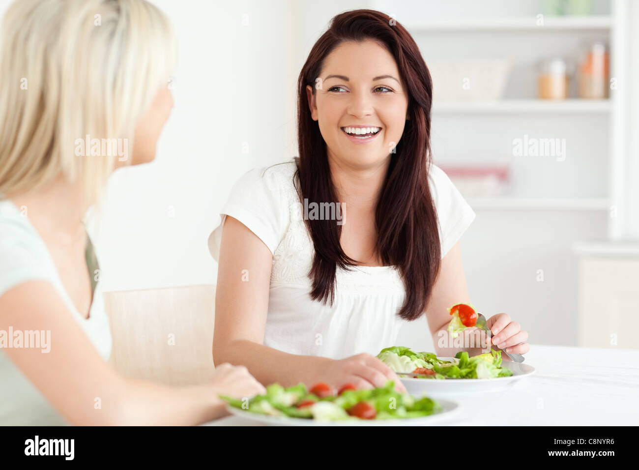 Portrait of laughing Women eating salad Stock Photo - Alamy