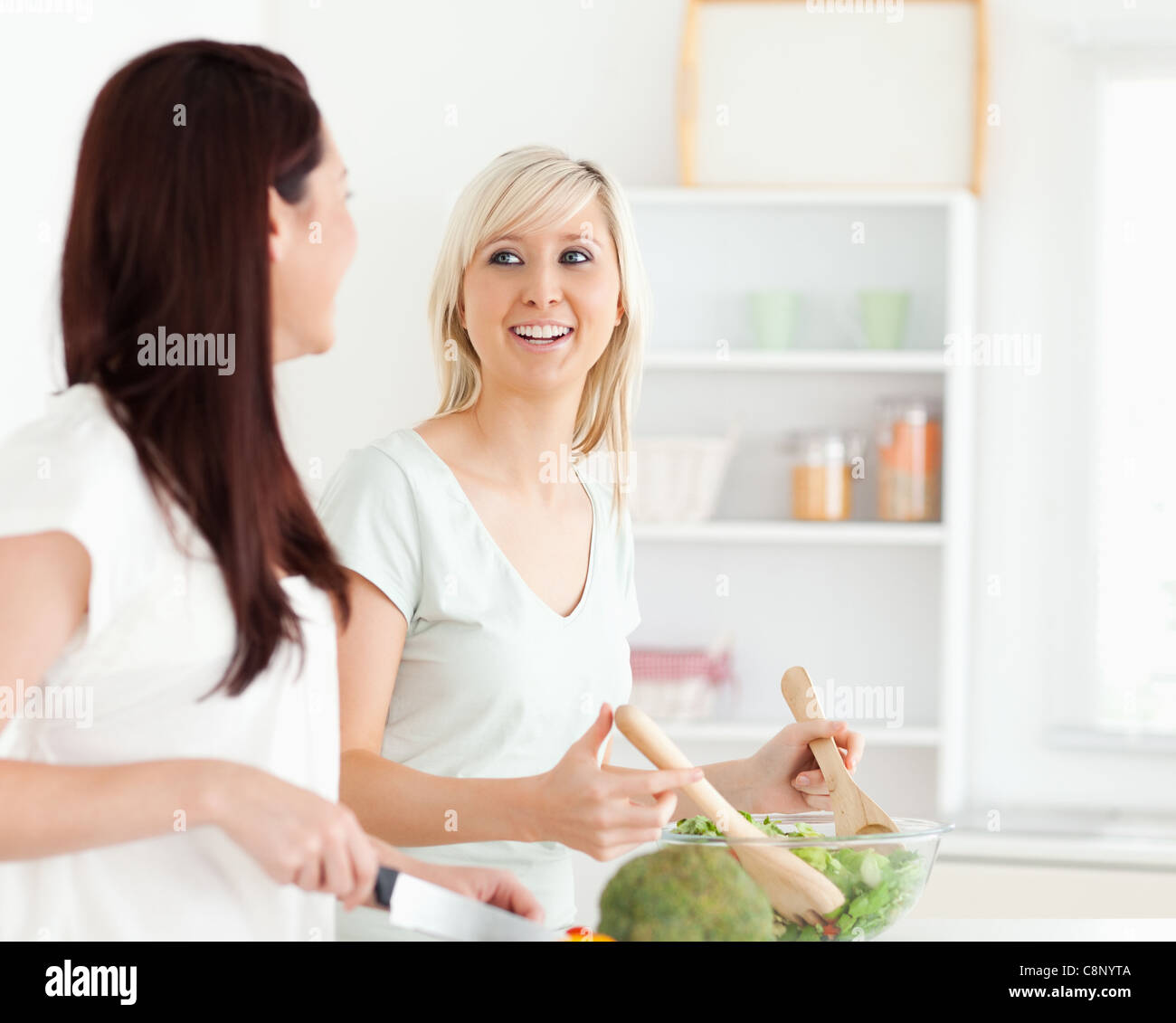 Cheering Women preparing dinner Stock Photo - Alamy