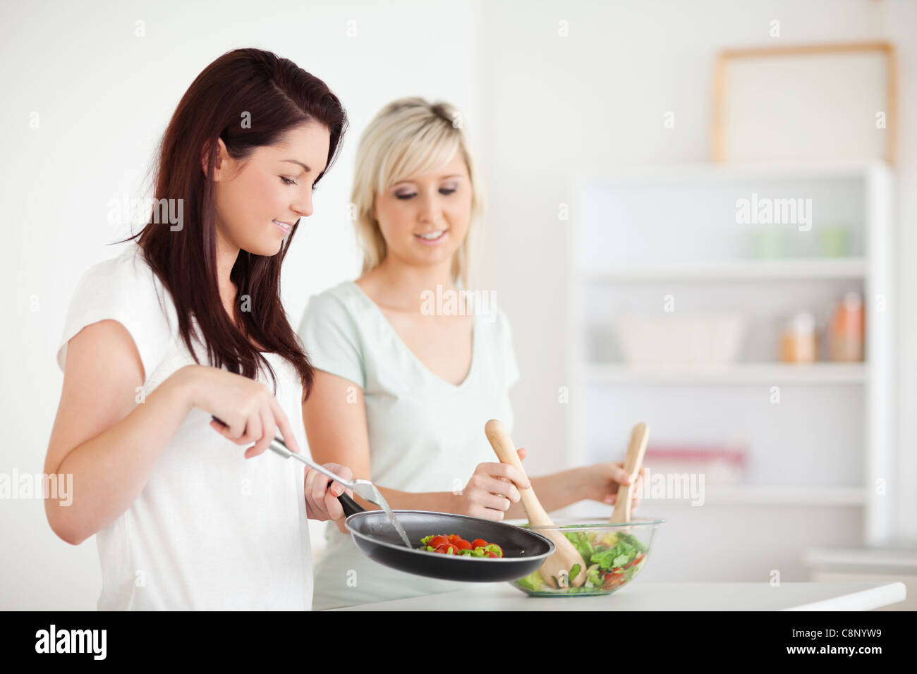 Gorgeous Women cooking dinner Stock Photo - Alamy