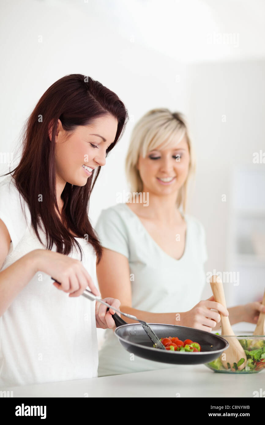 Cheerful Women cooking dinner Stock Photo - Alamy