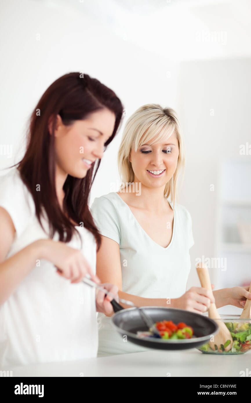 Joyful Women cooking dinner Stock Photo - Alamy