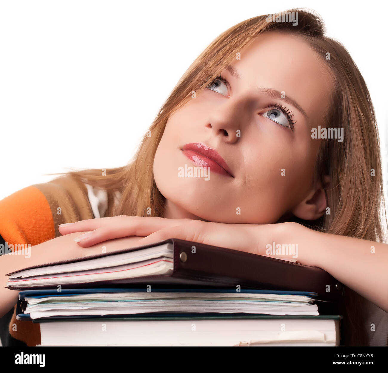 Young girl student with pile of books dreaming on white background ...
