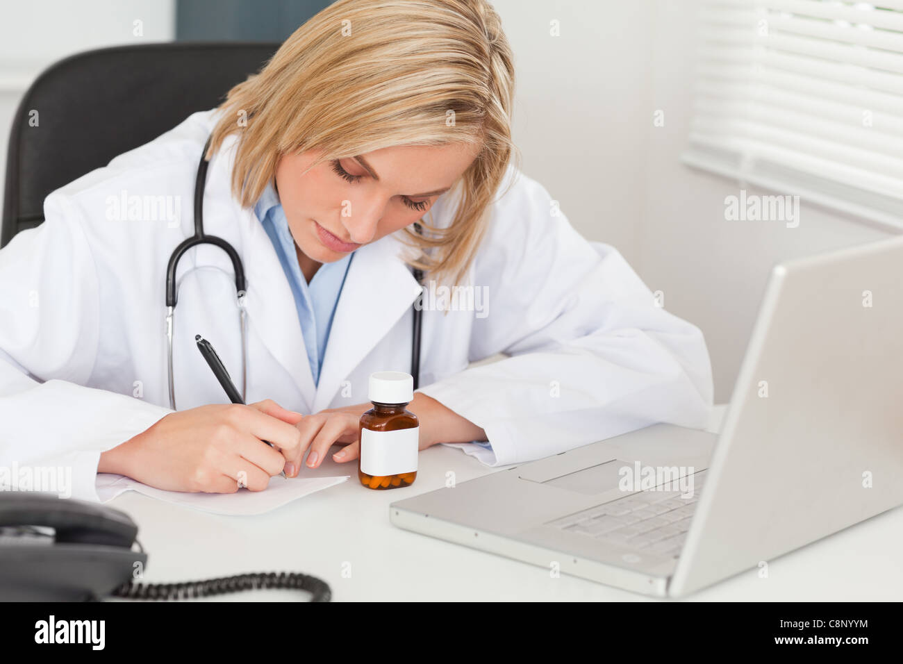 Doctor writing something down Stock Photo - Alamy