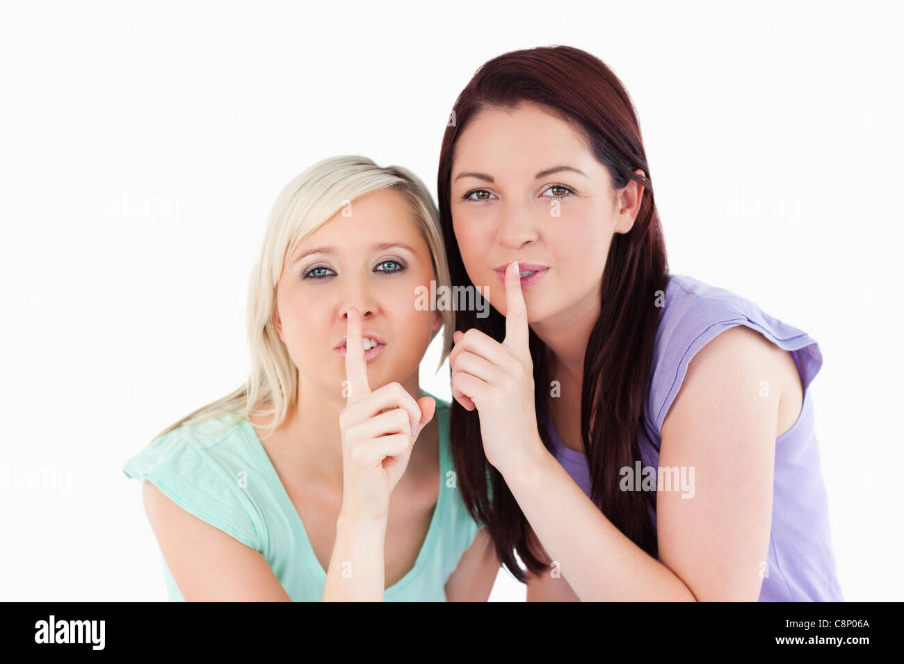 Beautiful women hushing Stock Photo - Alamy