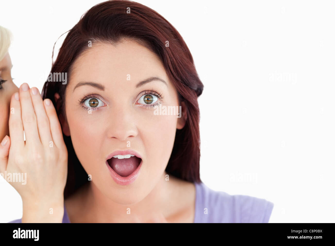 Portrait of a shocked women being told a secret Stock Photo - Alamy