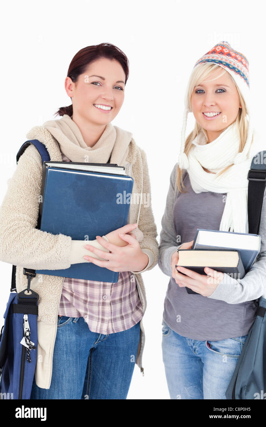 Two nice students with books looking Stock Photo - Alamy