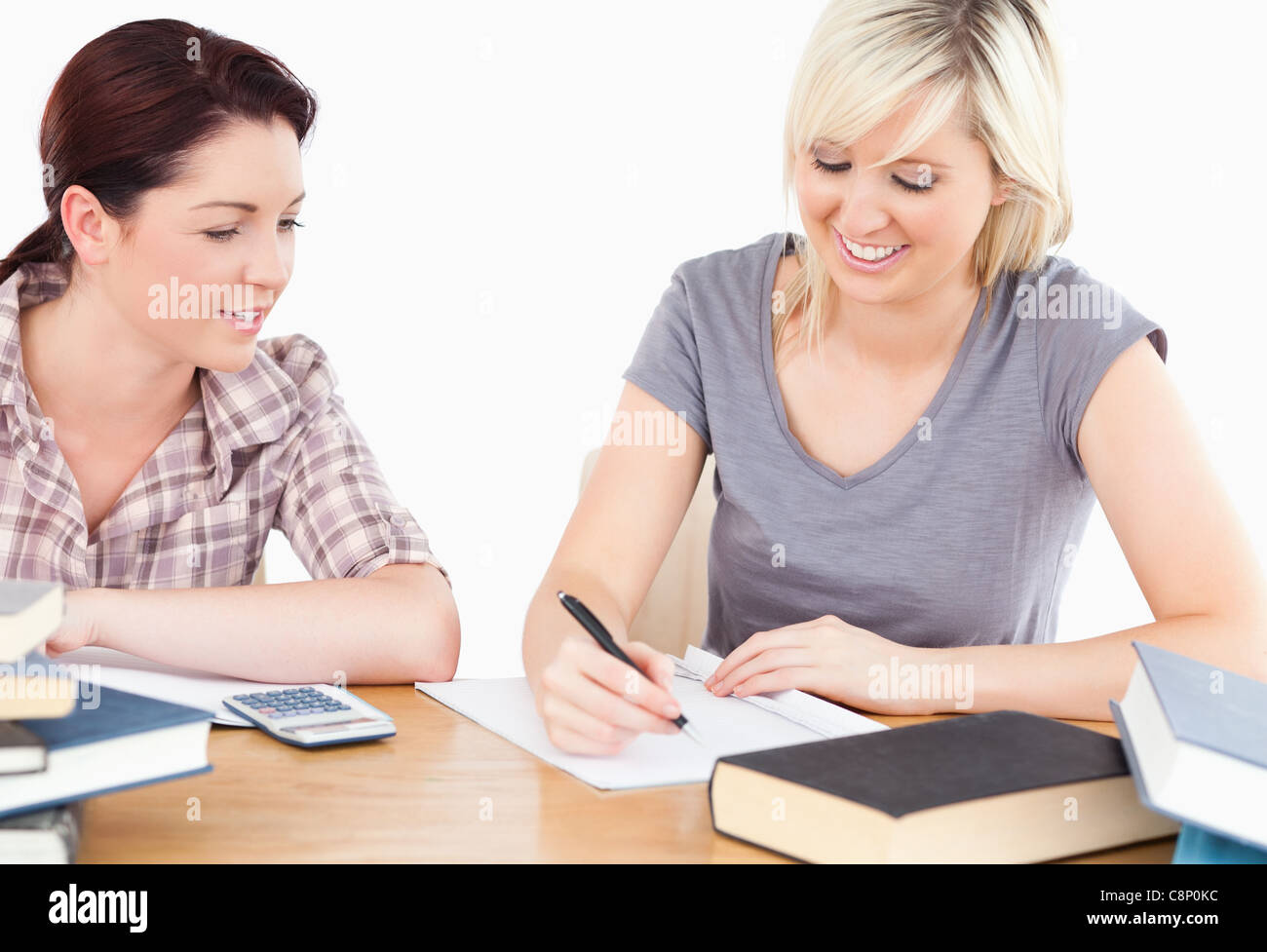 Cute students solving homework Stock Photo - Alamy