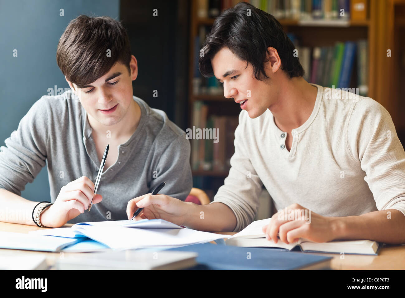 Handsome student working on an essay Stock Photo - Alamy