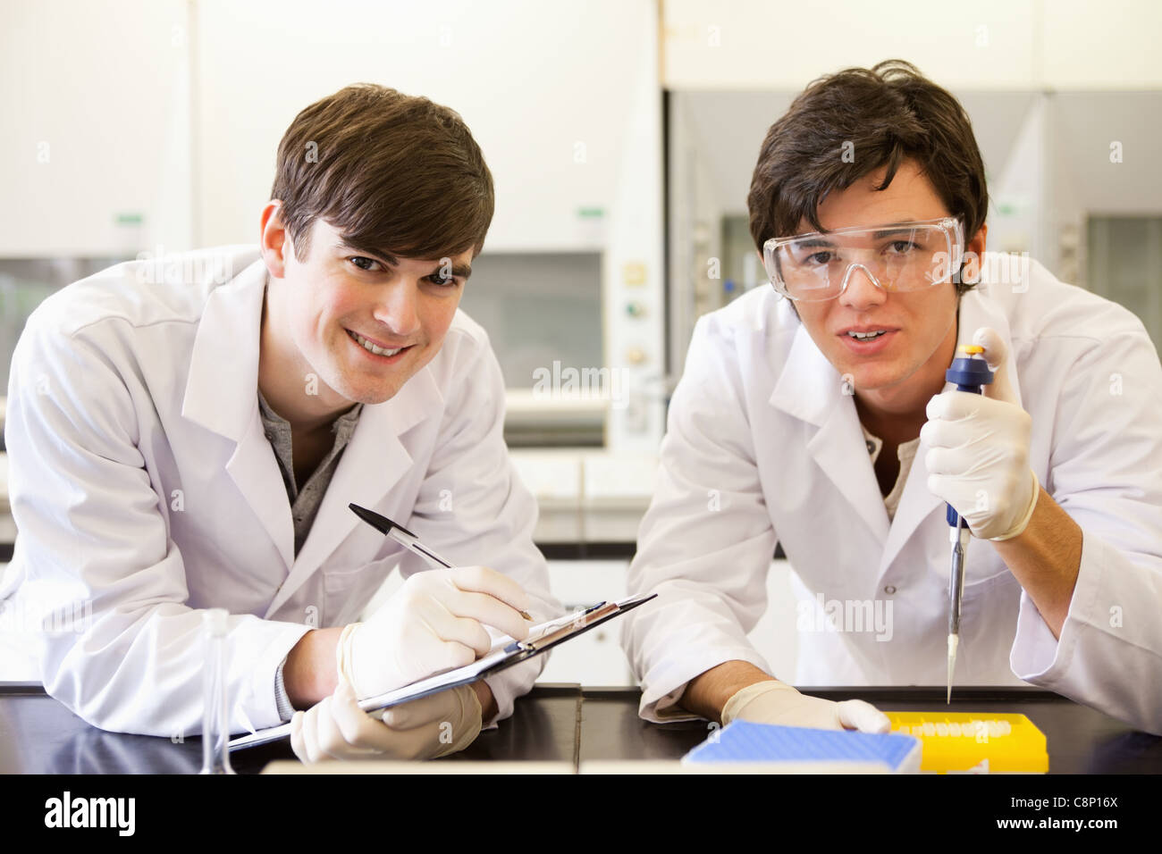 Handsome scientists making an experiment Stock Photo - Alamy