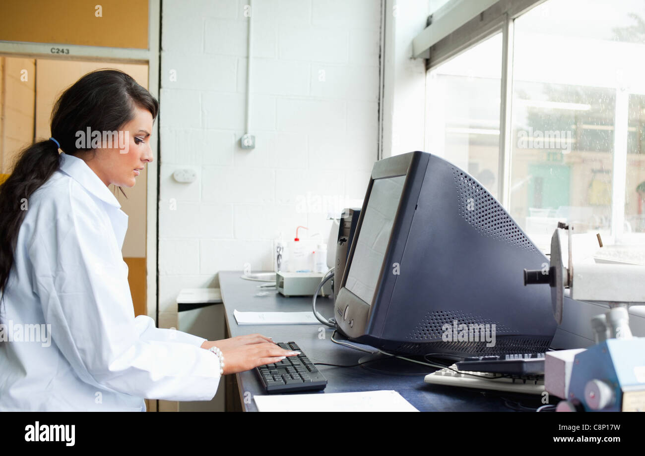 Female scientist using a monitor Stock Photo - Alamy