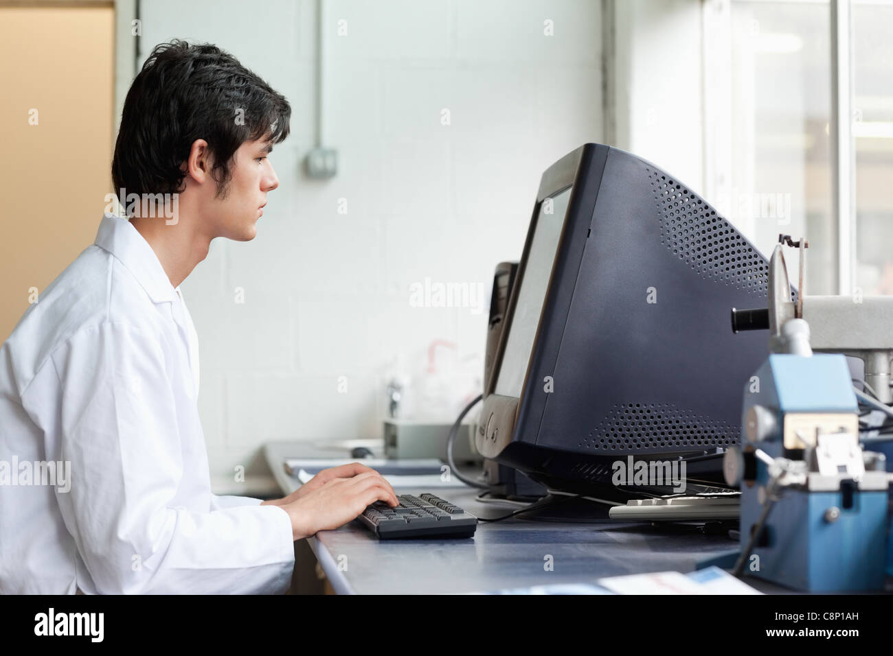 Student working with a monitor Stock Photo - Alamy