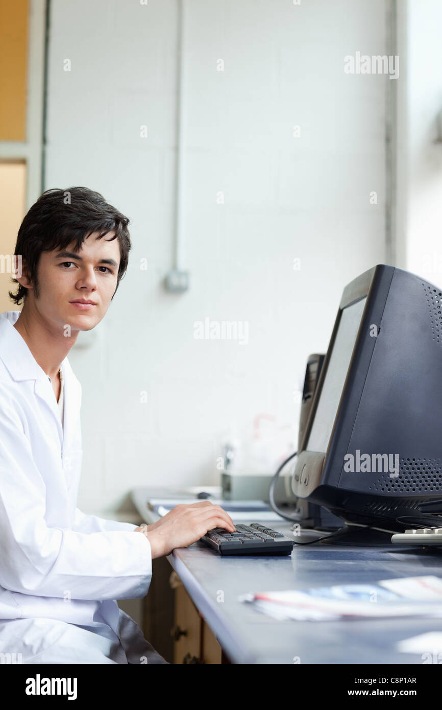 Portrait of a student posing with a monitor Stock Photo - Alamy
