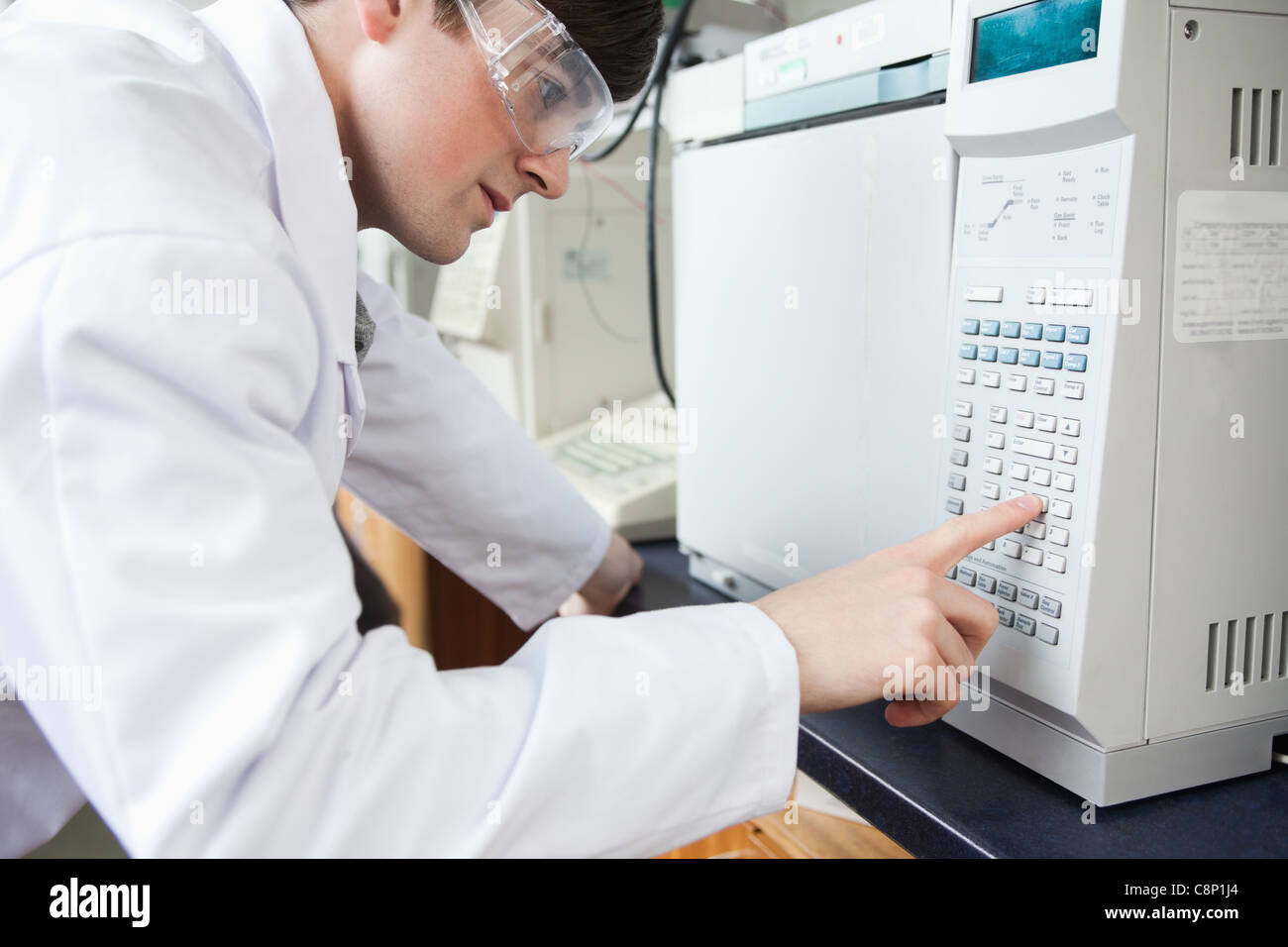 Science student using a laboratory chamber furnace in a laboratory ...