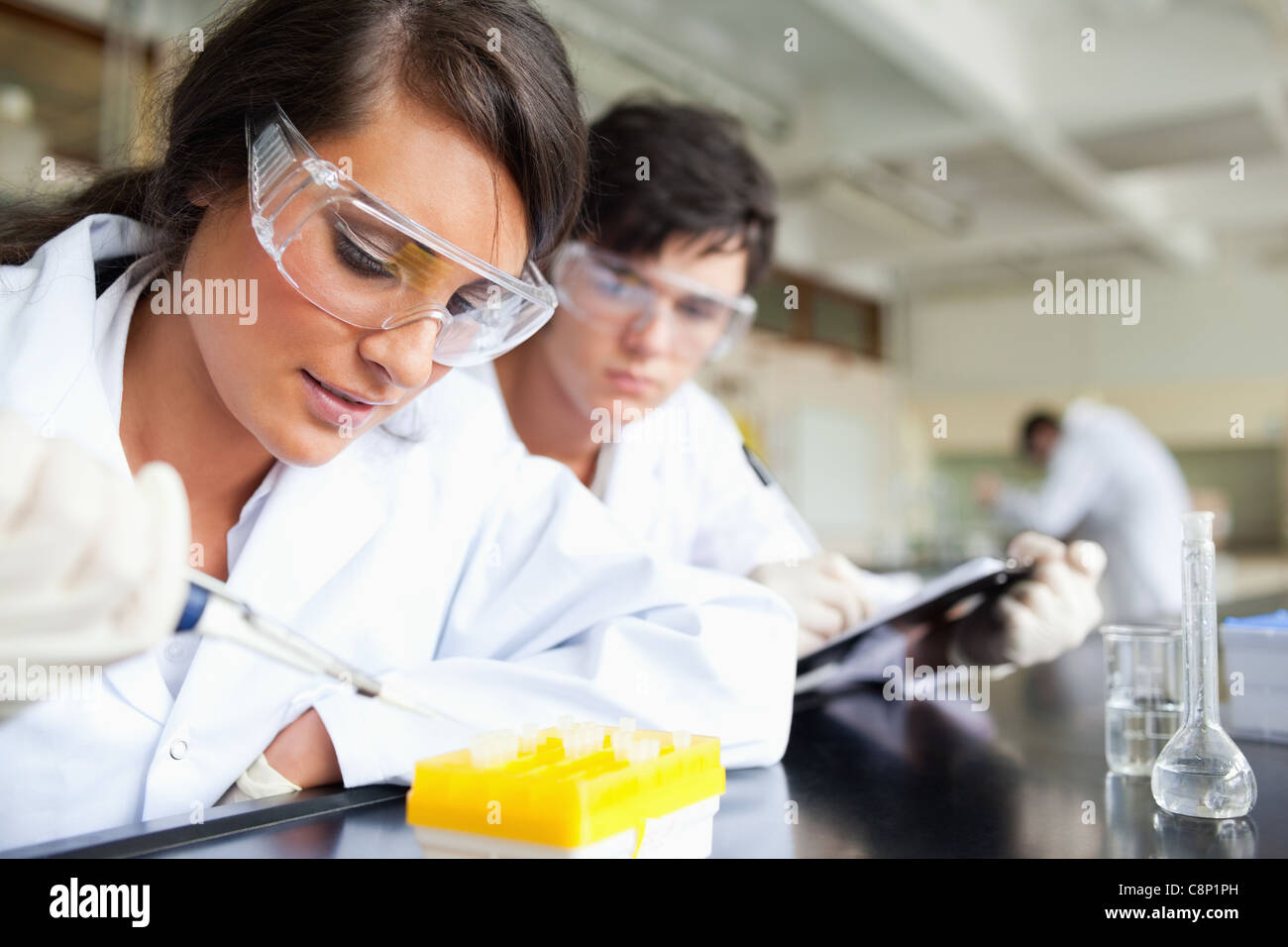 Two young scientists making an experiment Stock Photo - Alamy