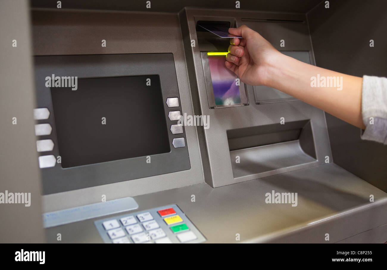 Hand inserting a credit card Stock Photo - Alamy