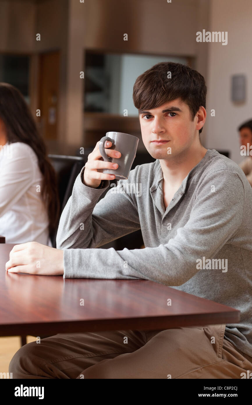 Portrait of a young man having a coffee Stock Photo - Alamy