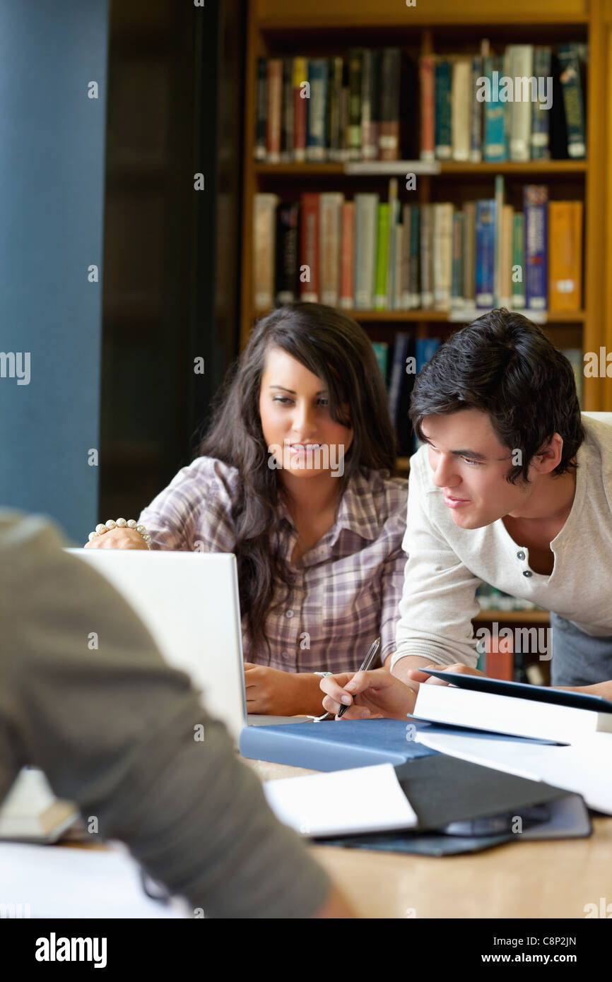 Portrait of smiling students working together Stock Photo - Alamy