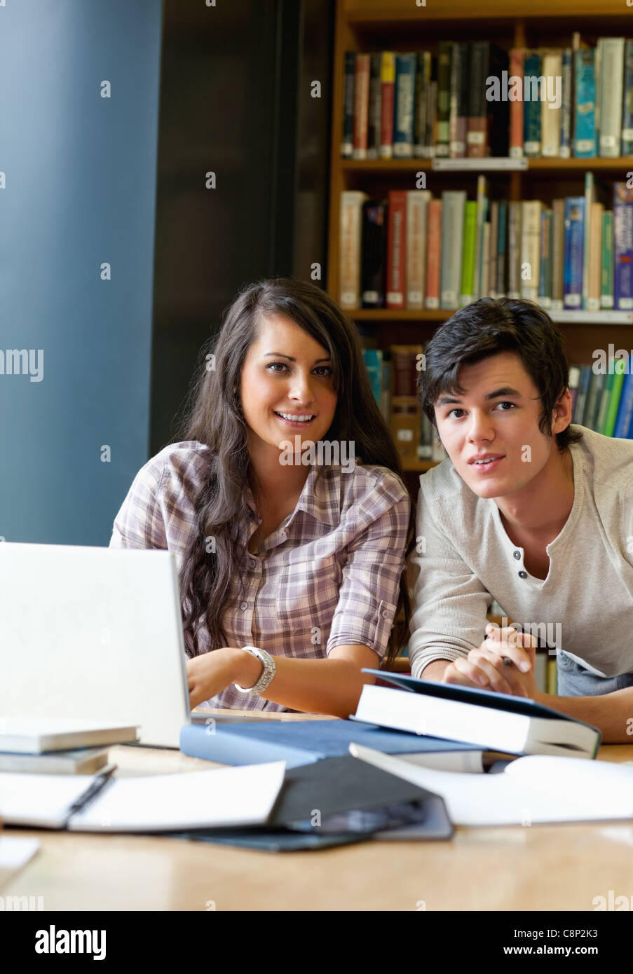 Portrait of good looking students working together Stock Photo - Alamy