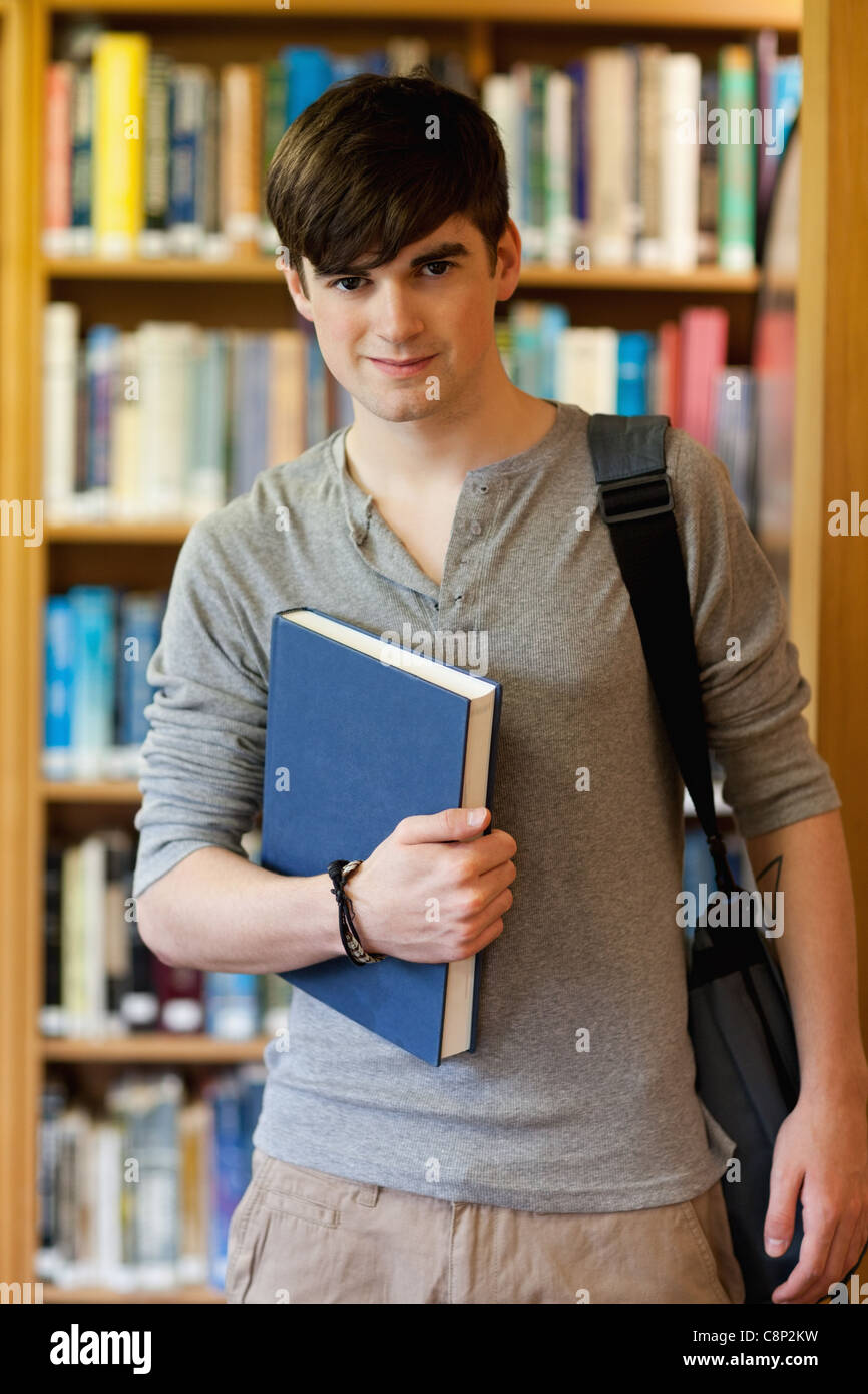 Young student holding a book Stock Photo - Alamy