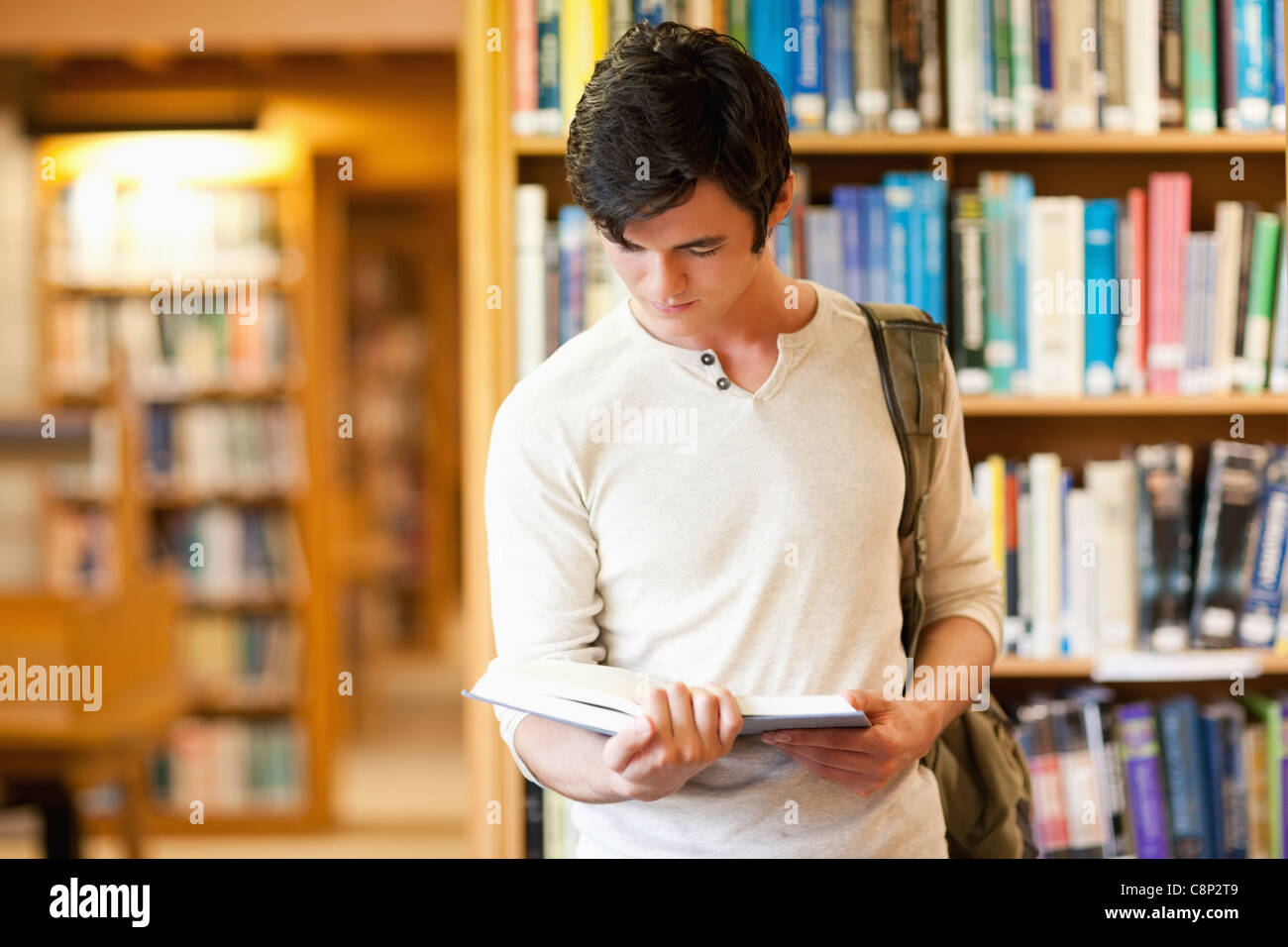 Serious student reading a book Stock Photo - Alamy
