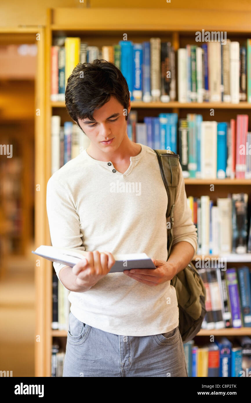 Portrait of a serious student reading a book Stock Photo - Alamy