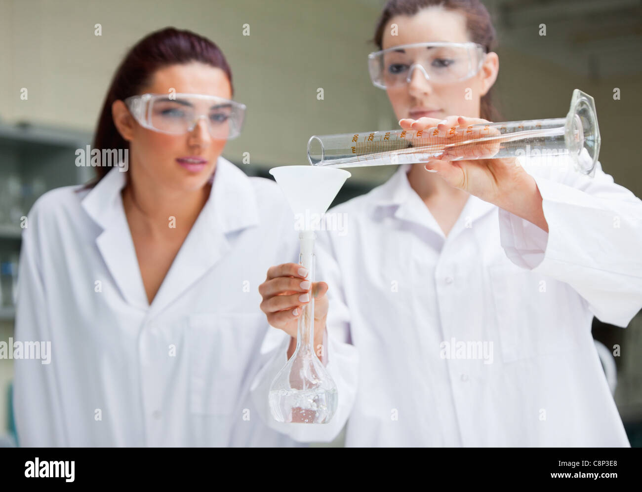 Gorgeous scientists doing an experiment Stock Photo - Alamy