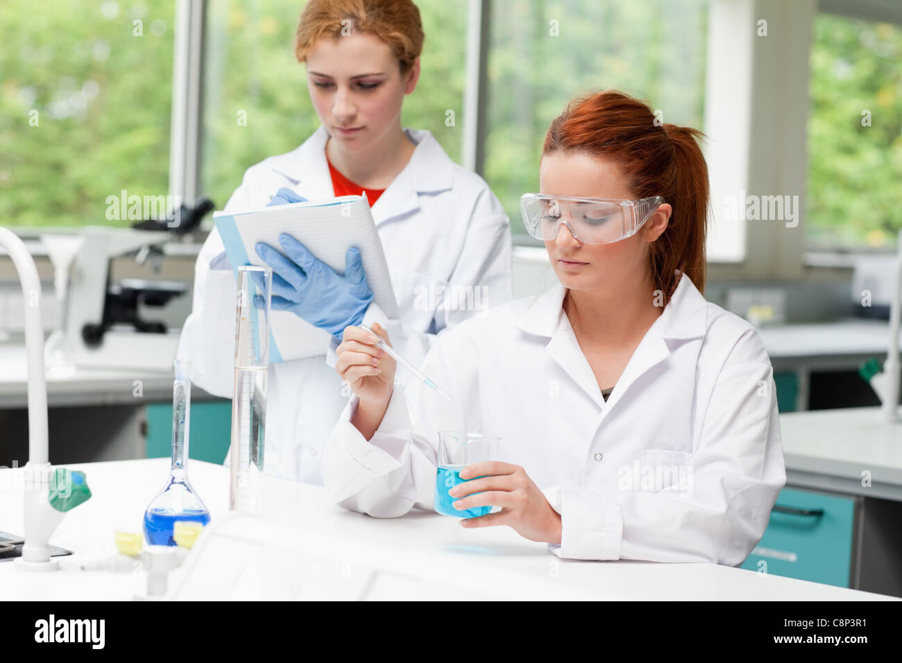 Science students doing an experiment Stock Photo - Alamy