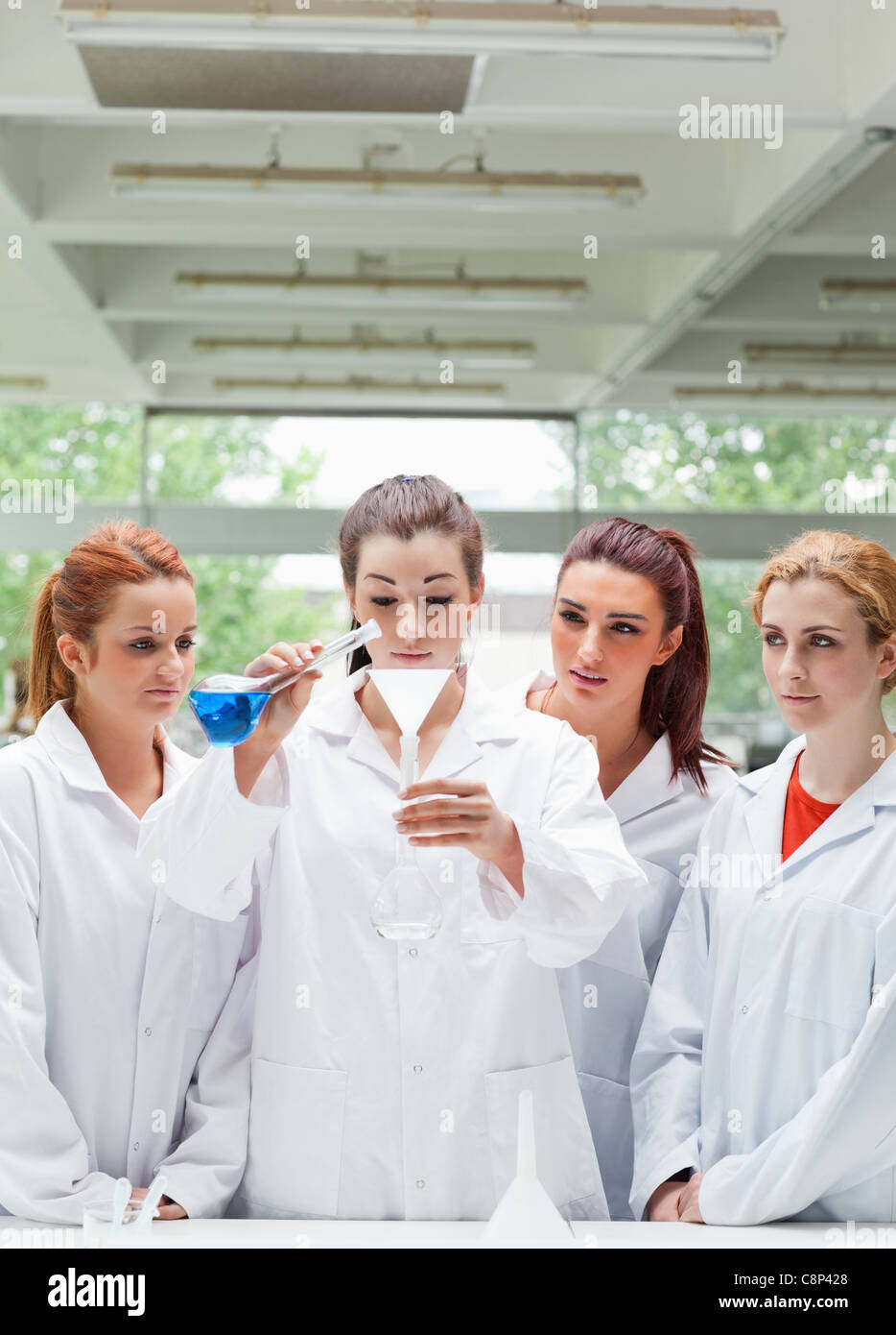 Portrait of a scientist holding liquid in a flask hi-res stock ...
