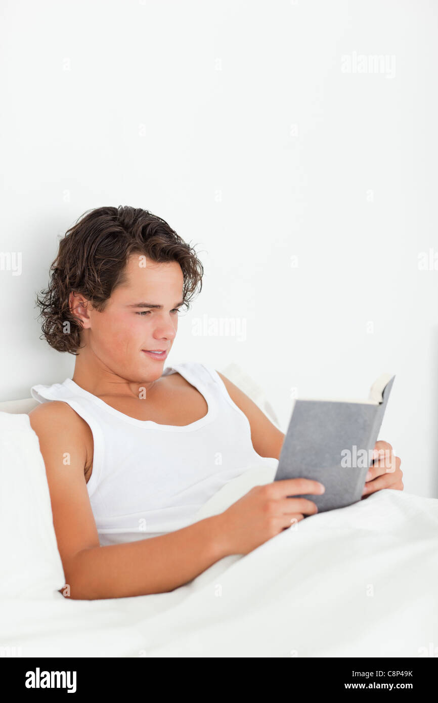 Portrait of a cute man reading a book Stock Photo - Alamy