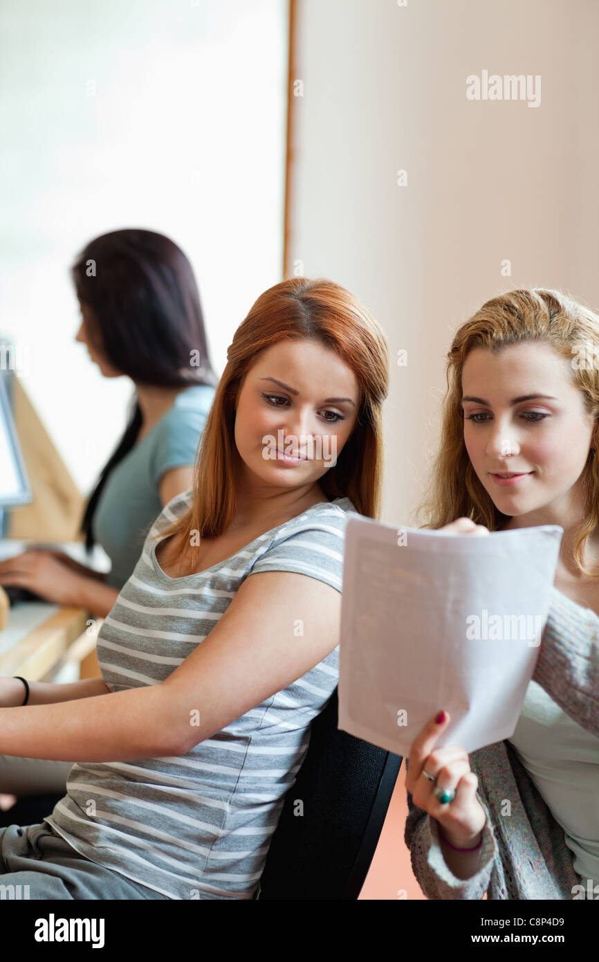 Portrait of a student showing her notes to her classmate Stock Photo ...