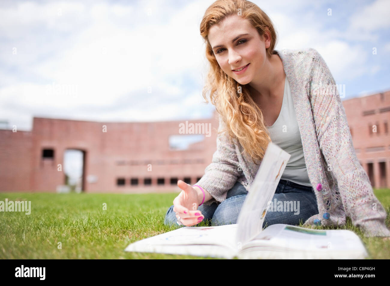 Woman posing with a book Stock Photo - Alamy