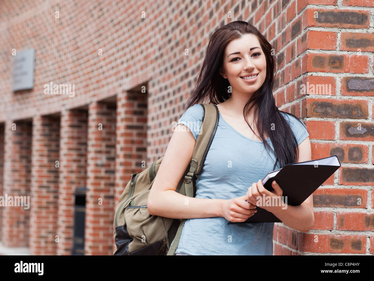 Student posing with a binder Stock Photo - Alamy