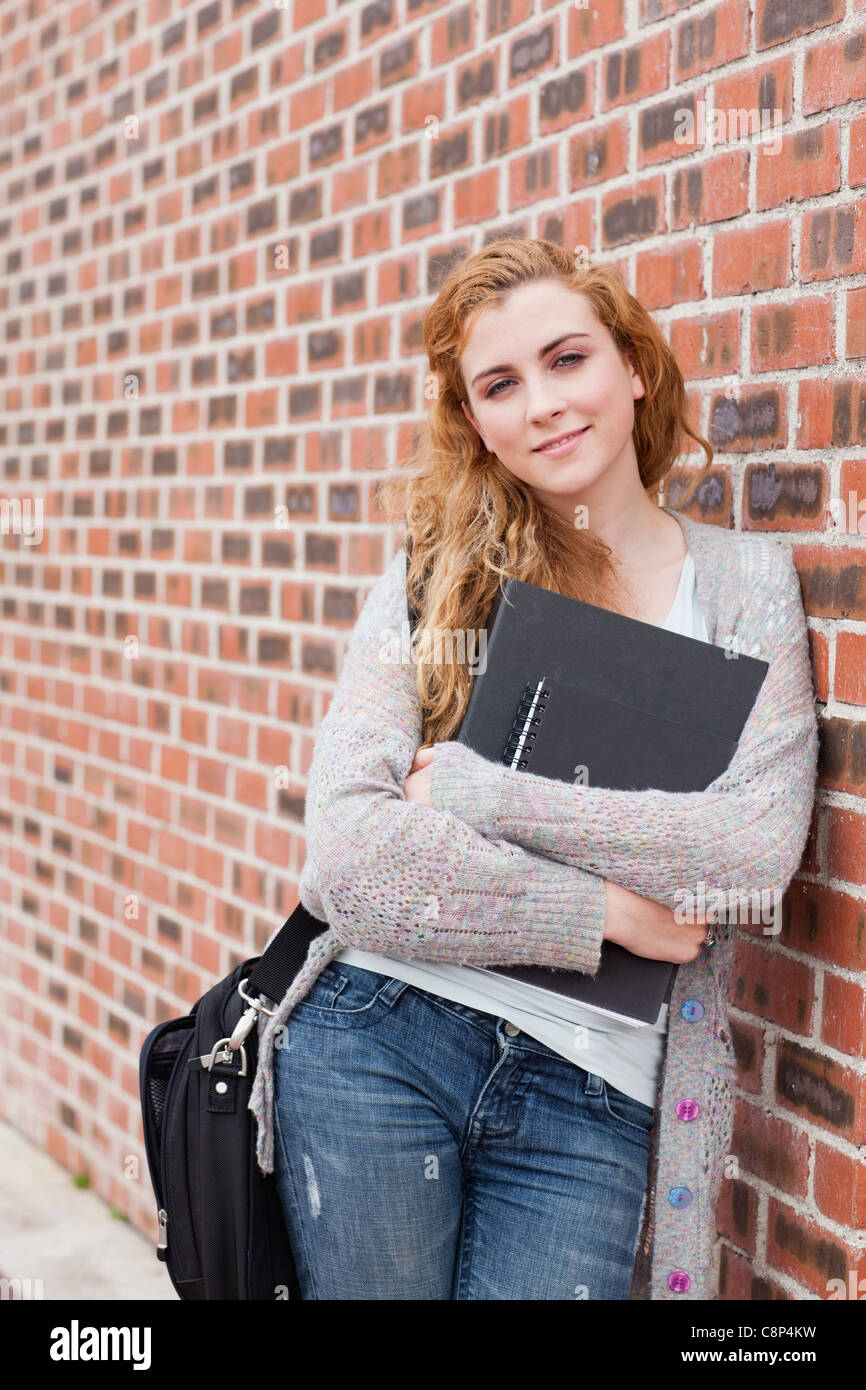 Portrait of a lovely student holding her binder Stock Photo - Alamy