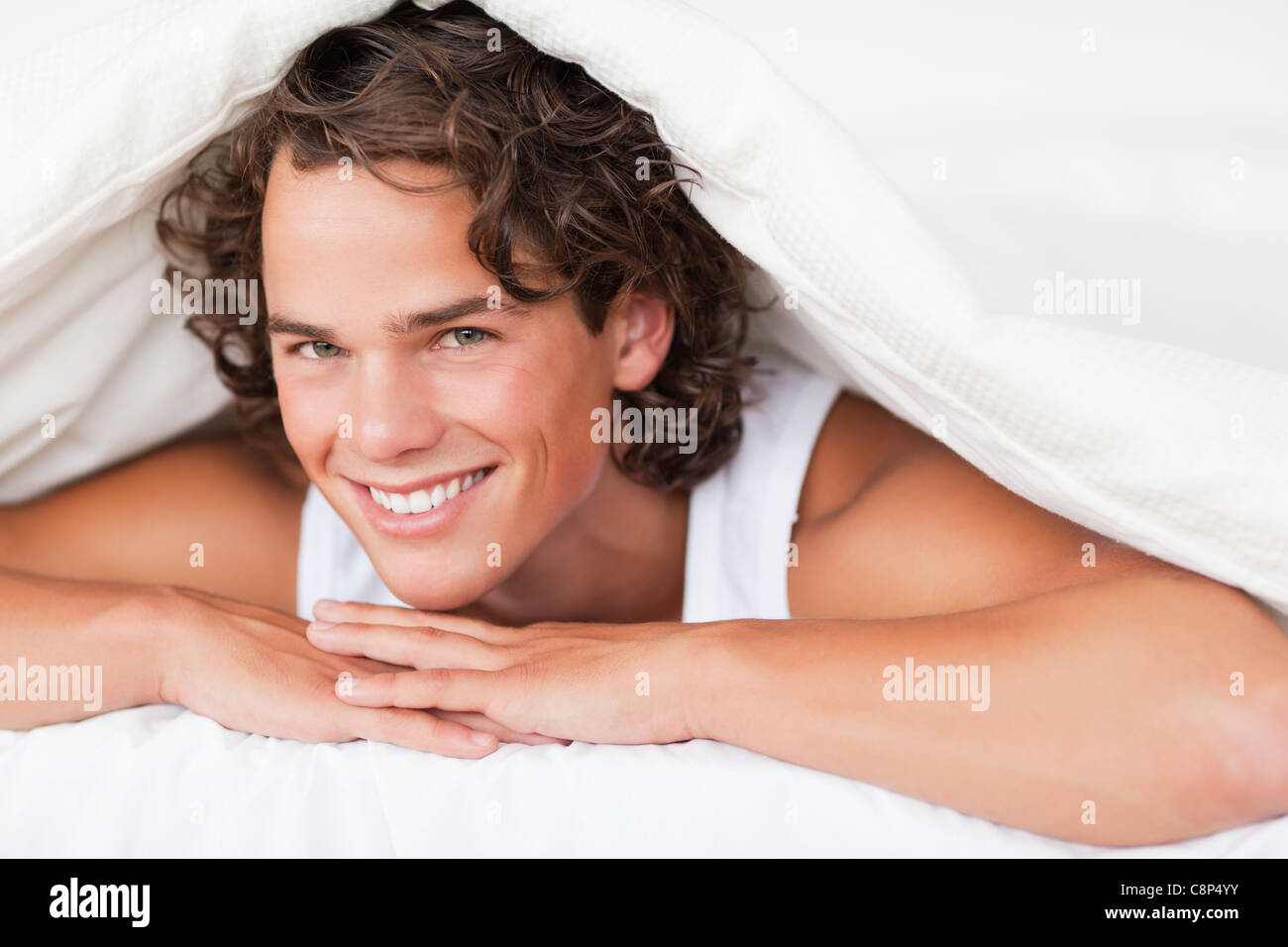 Man looking under bed sheet hi-res stock photography and images - Alamy