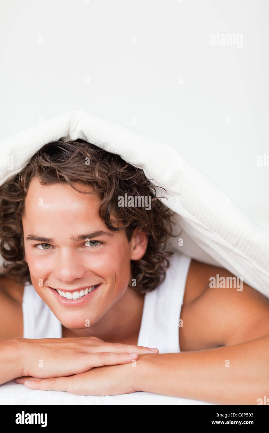 Man looking under bed sheet hi-res stock photography and images - Alamy