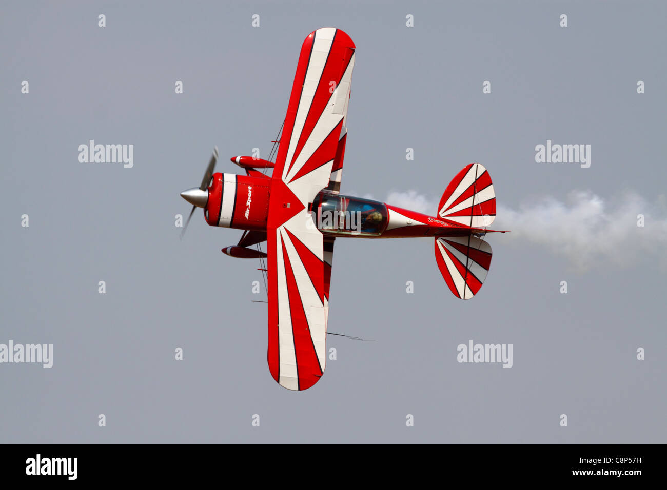 Red-white painted Pitts Special biplane seen from above, blue sky in ...