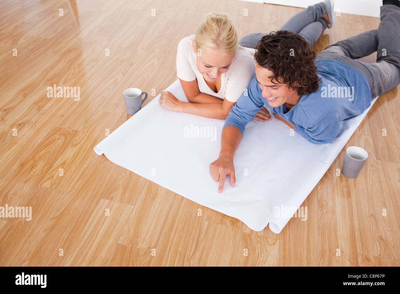 Young man showing a point on a plan to his fiance Stock Photo - Alamy