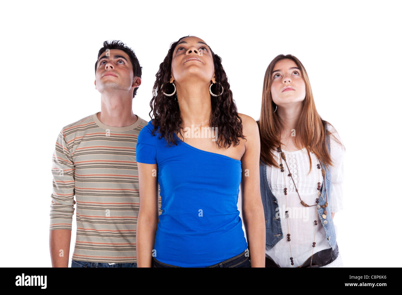 Three teenagers friends looking up to the copy space (isolated on white ...