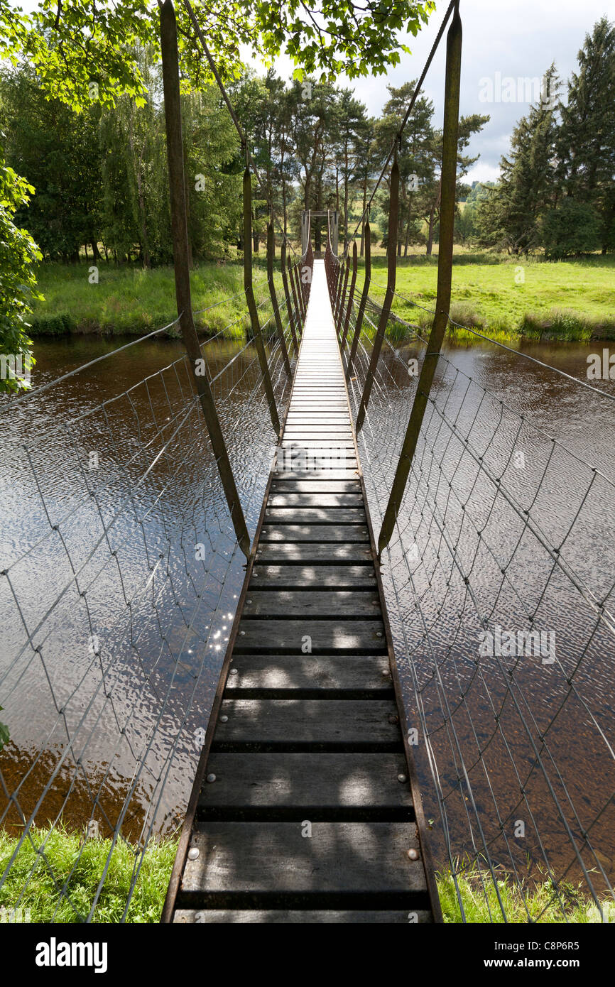 Looking along the length of a small suspension swing bridge over the ...