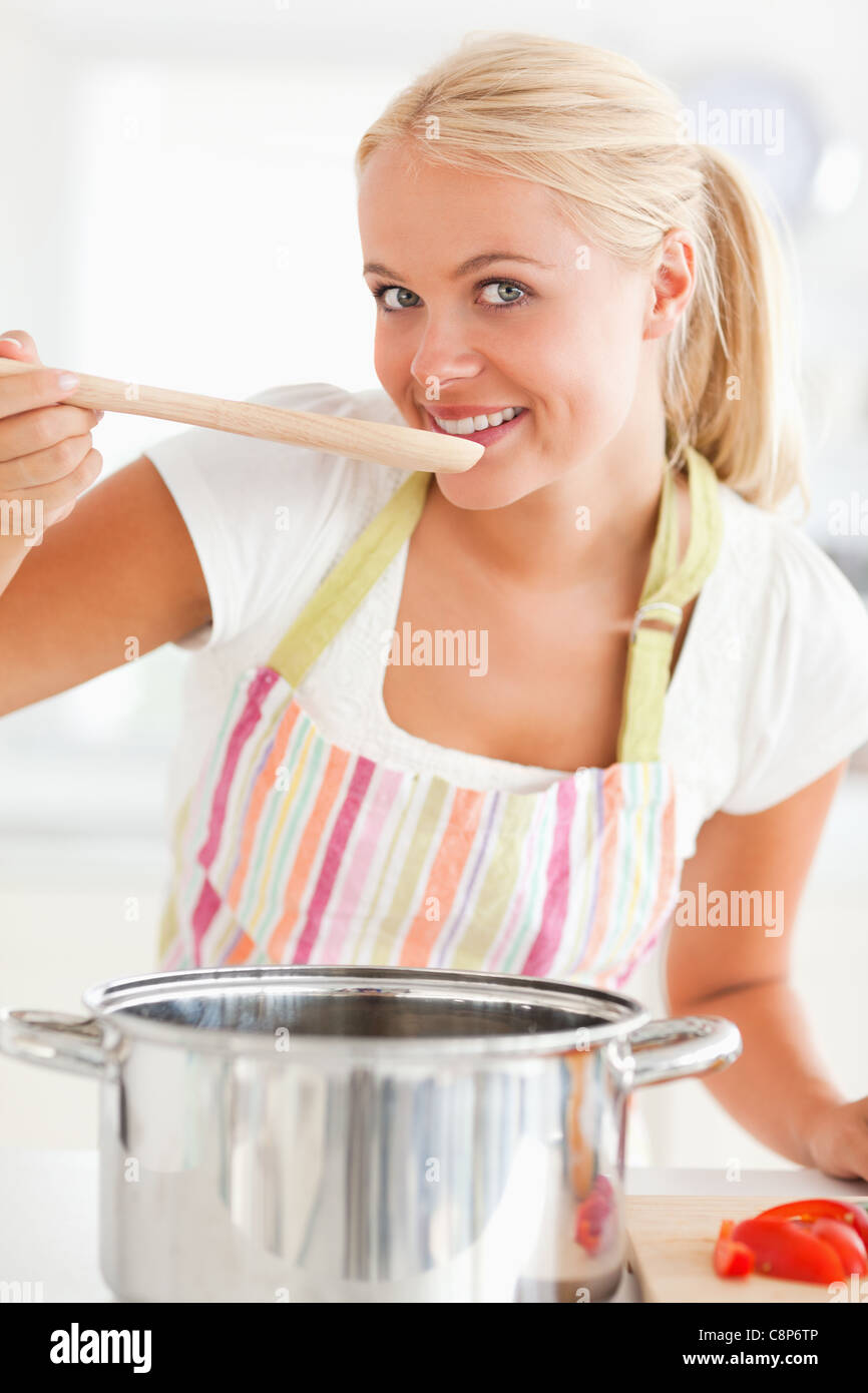 Portrait of a woman tasting her meal Stock Photo - Alamy