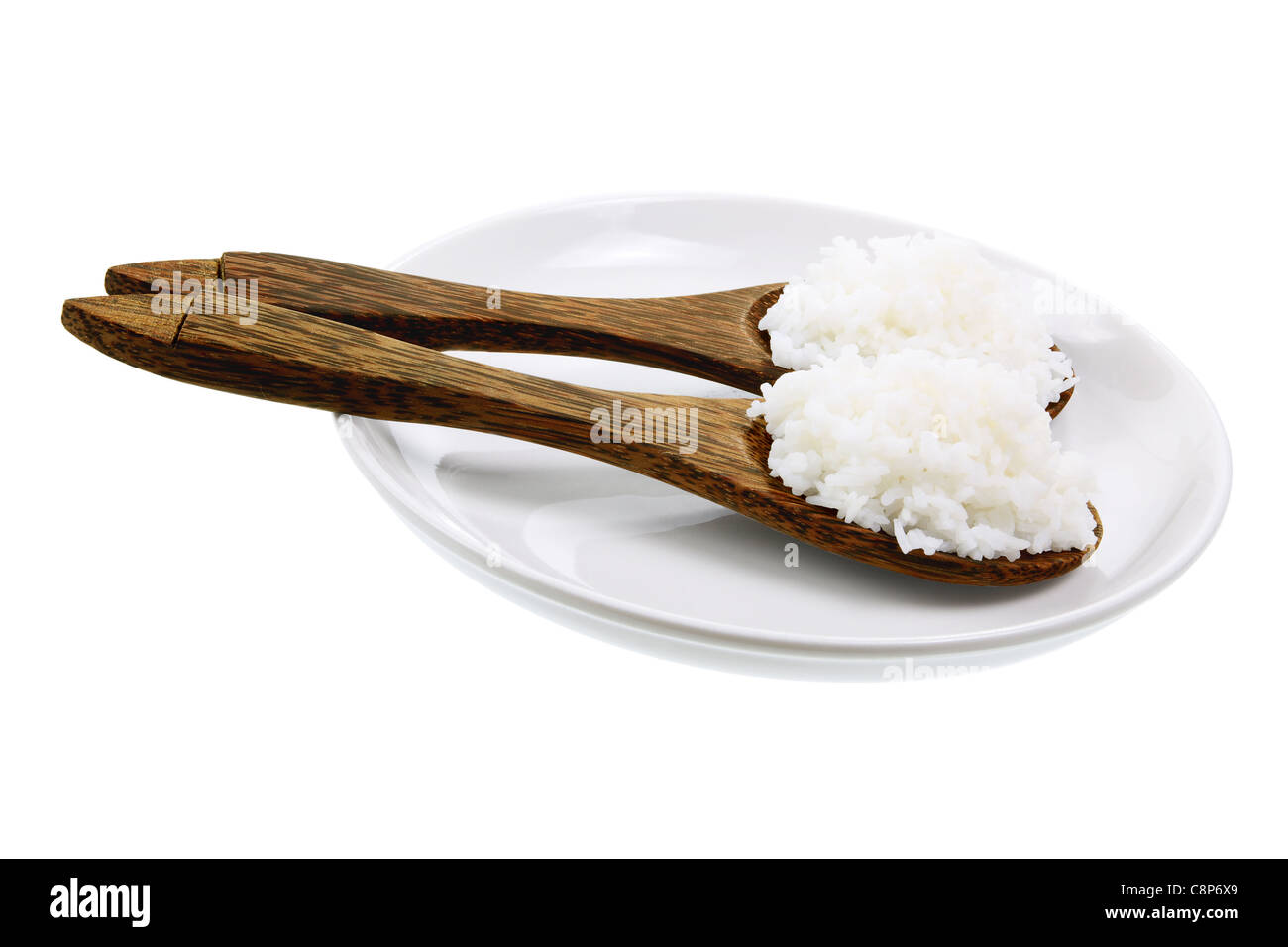 Wooden Spoons with Steamed Rice on Plate Stock Photo - Alamy