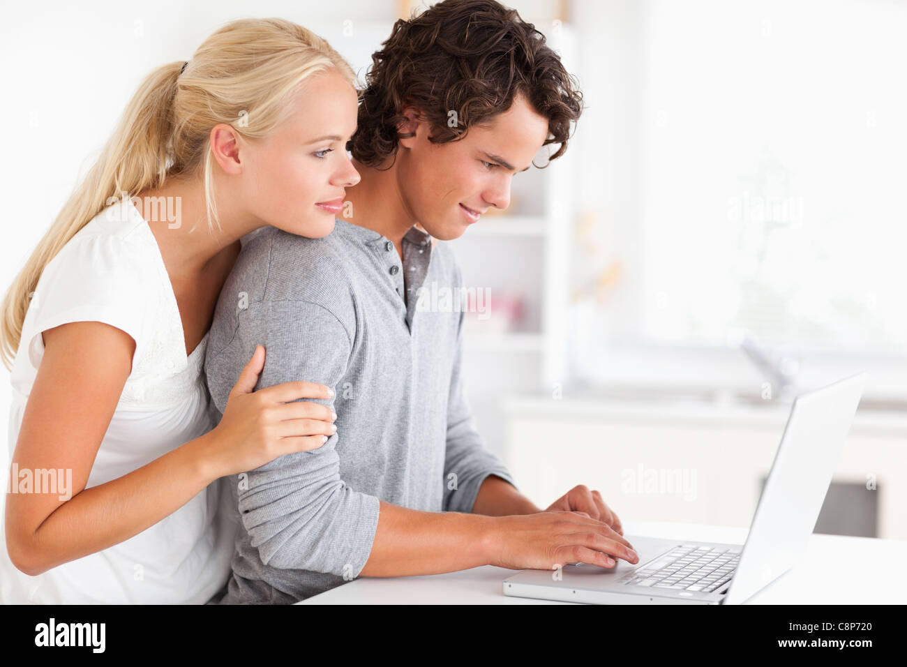 Lovely couple using a notebook Stock Photo - Alamy