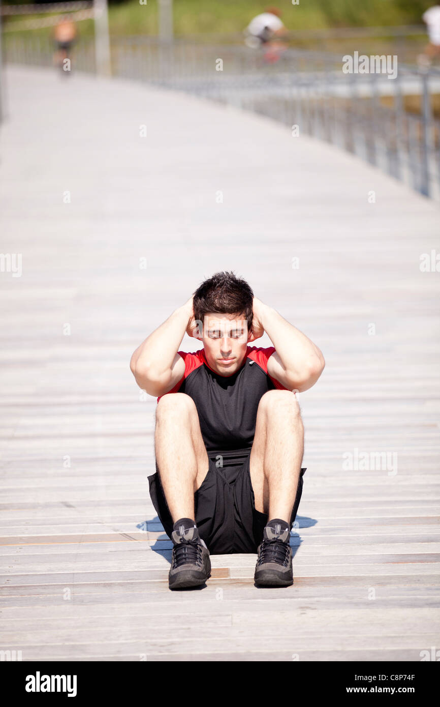 Athlete man at the city park making some abdominals Stock Photo - Alamy