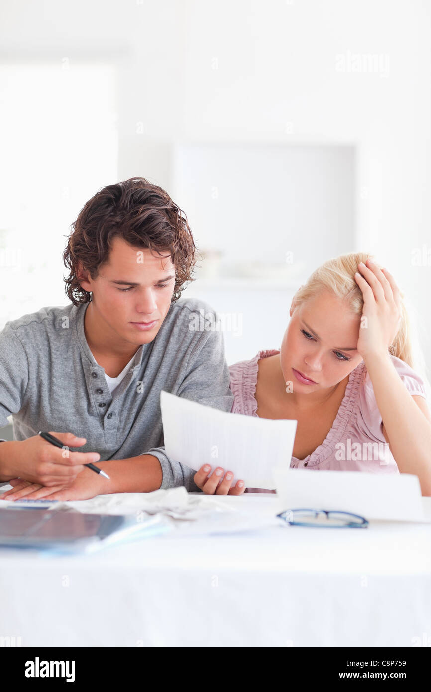 Worried Couple with Paperwork Stock Photo - Alamy